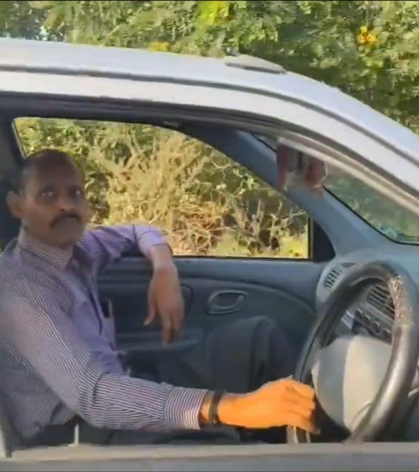 Man Drives Car with Feet - Viral Video Sparks Safety Debate - DriveSpark